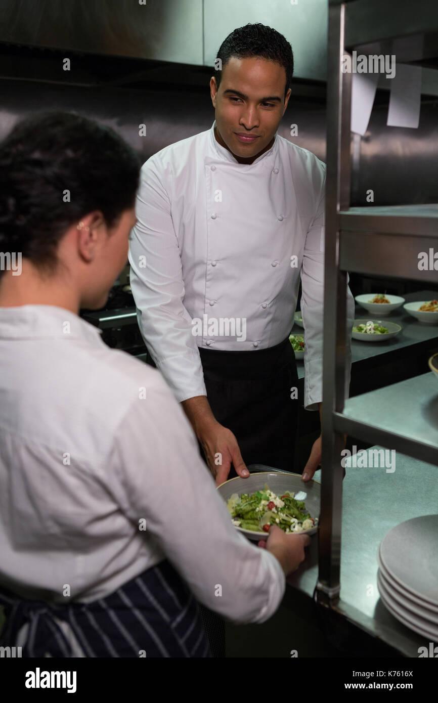 Chef handing food dish waitress hi-res stock photography and images - Alamy