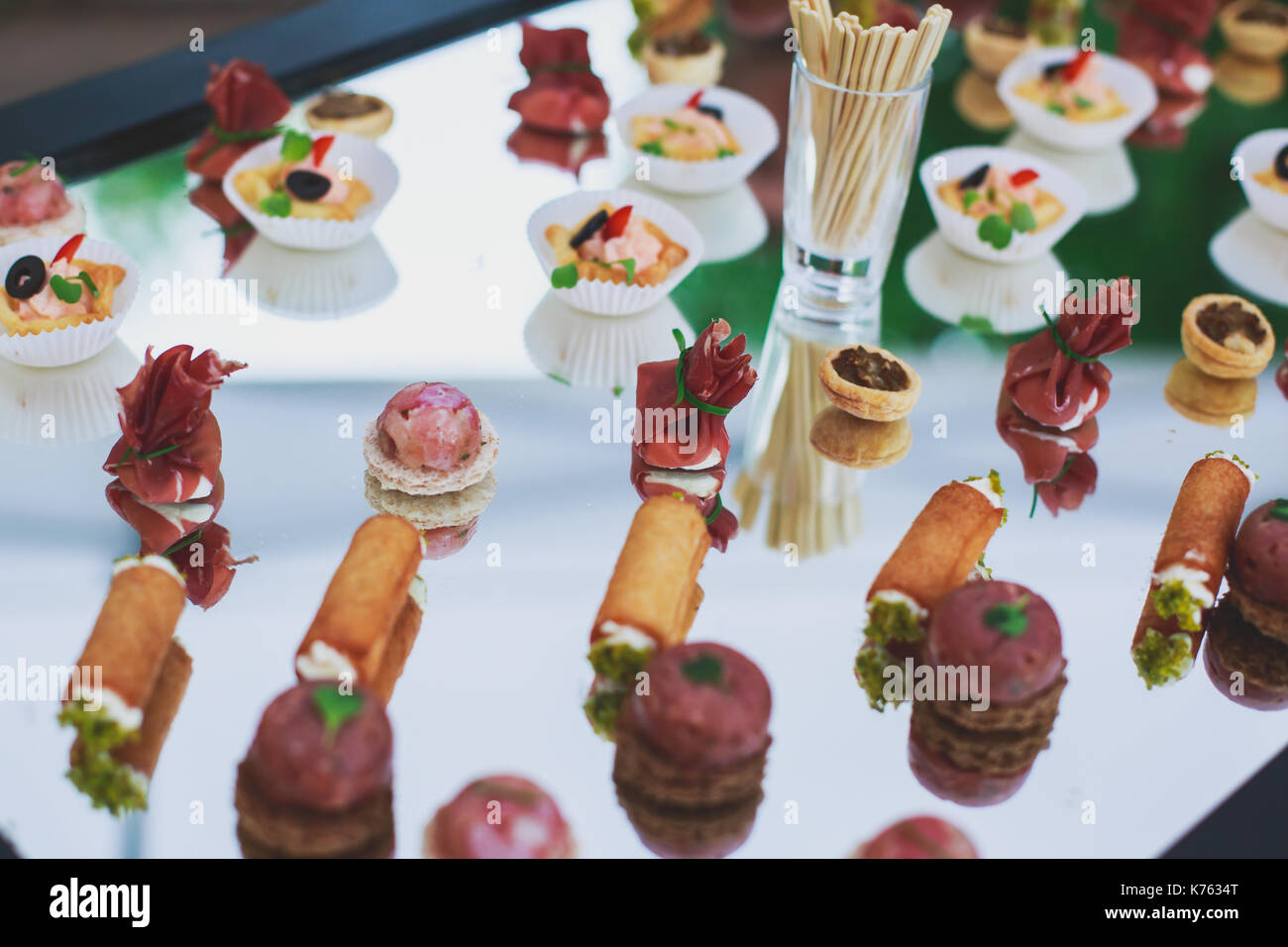 Beautifully decorated catering banquet table with different food snacks ...