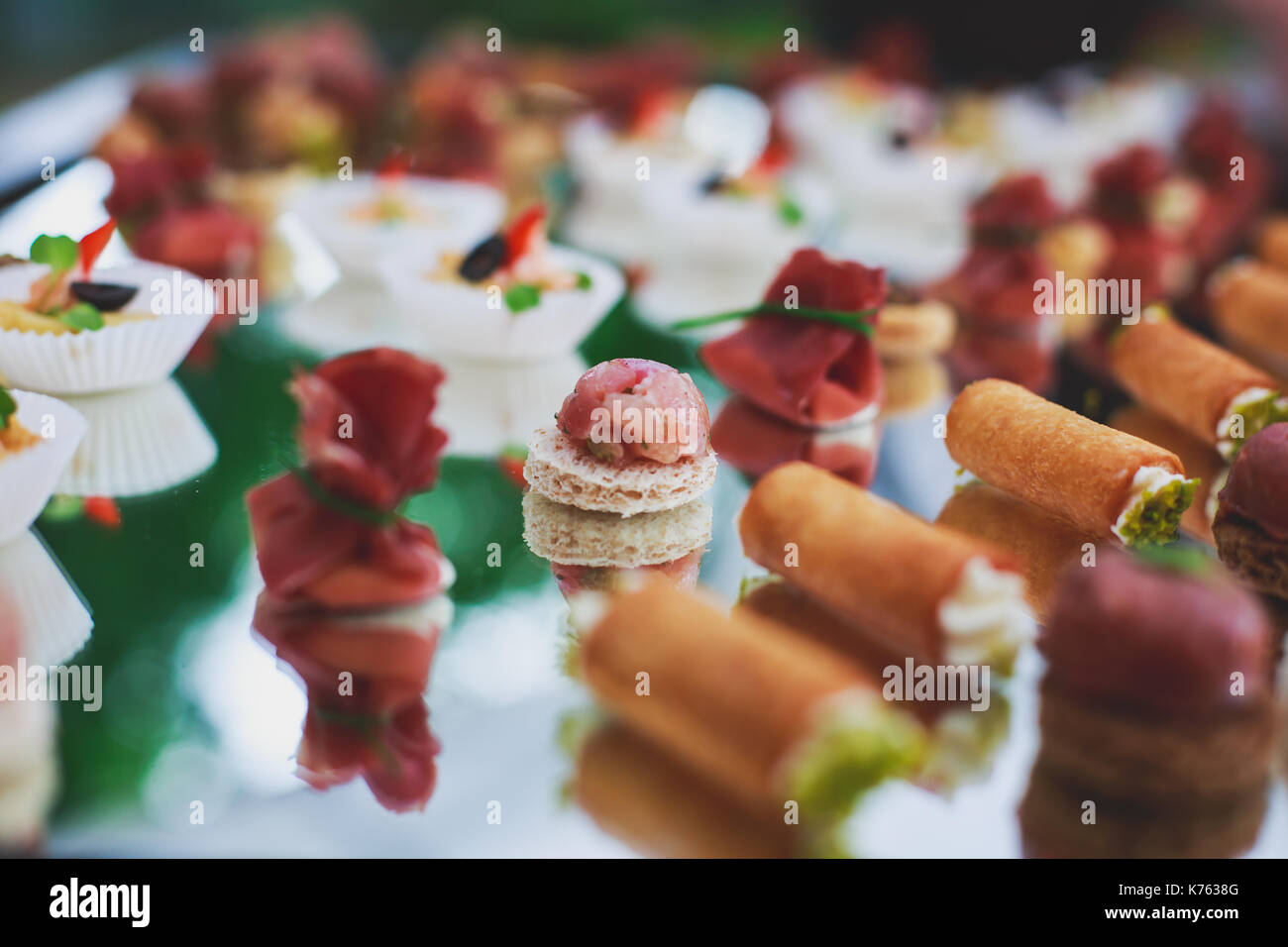 Beautifully decorated catering banquet table with different food snacks ...