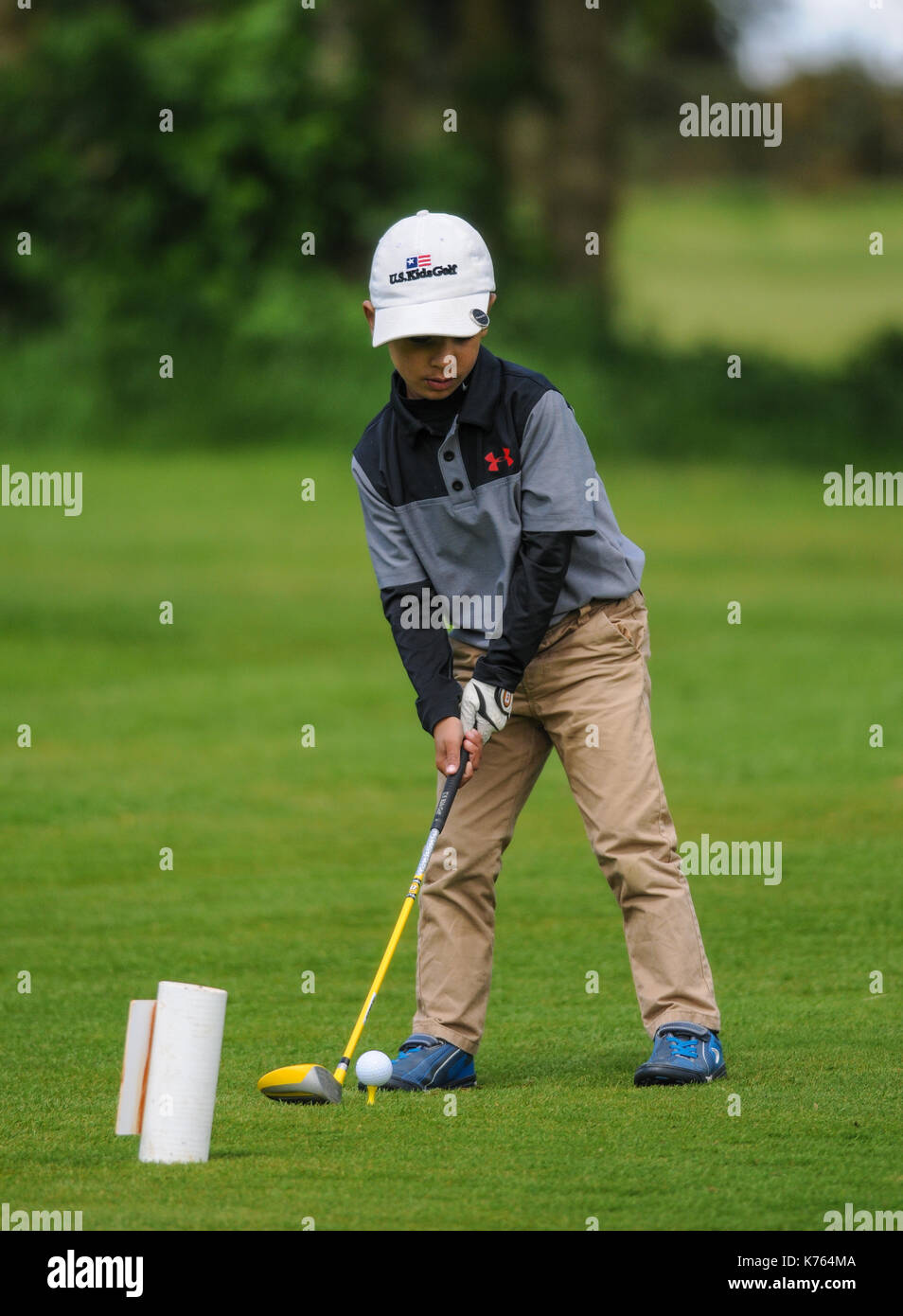 Junior child teenager playing golf in England UK Stock Photo - Alamy