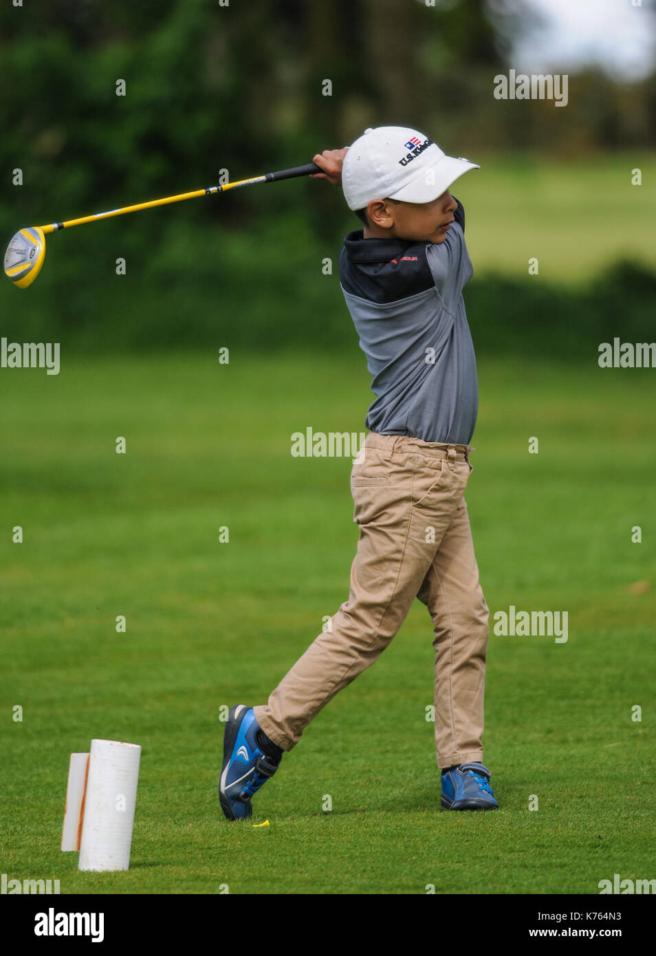 Junior child teenager playing golf in England UK Stock Photo - Alamy