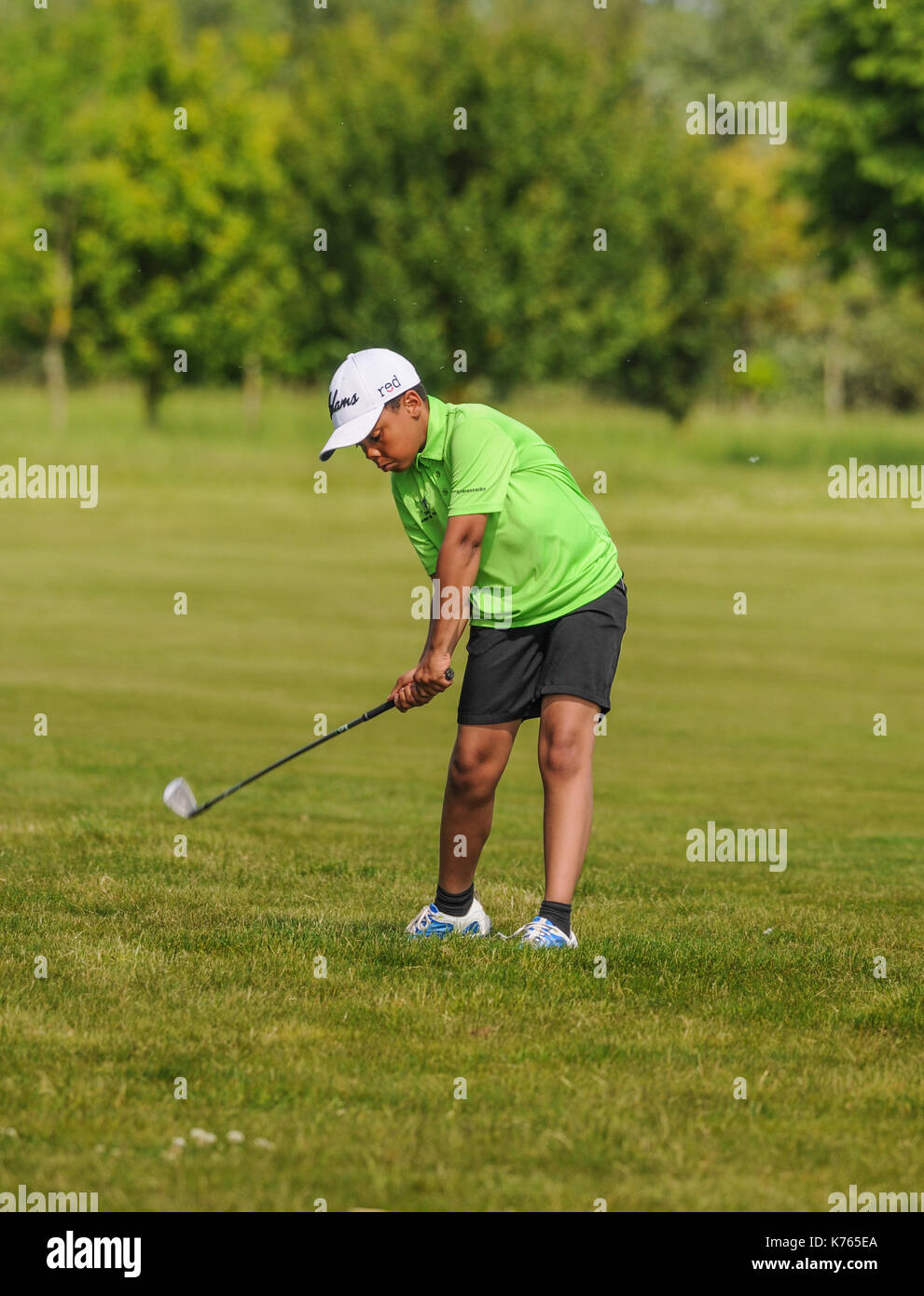 Junior child teenager playing golf in England UK Stock Photo - Alamy