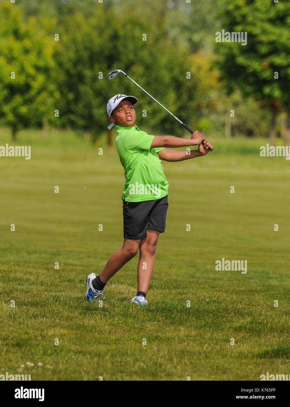 Junior child teenager playing golf in England UK Stock Photo - Alamy