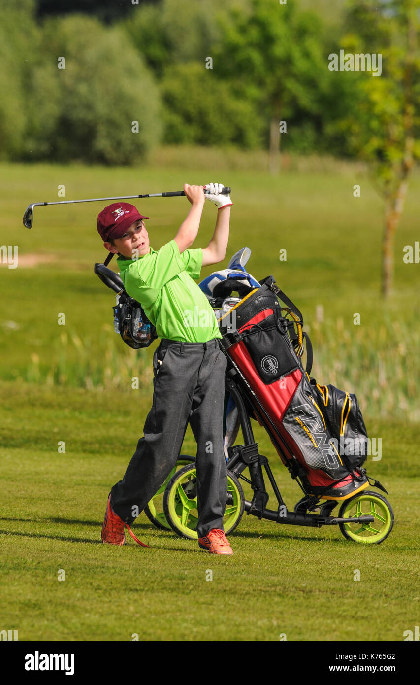 Junior child teenager playing golf in England UK Stock Photo - Alamy