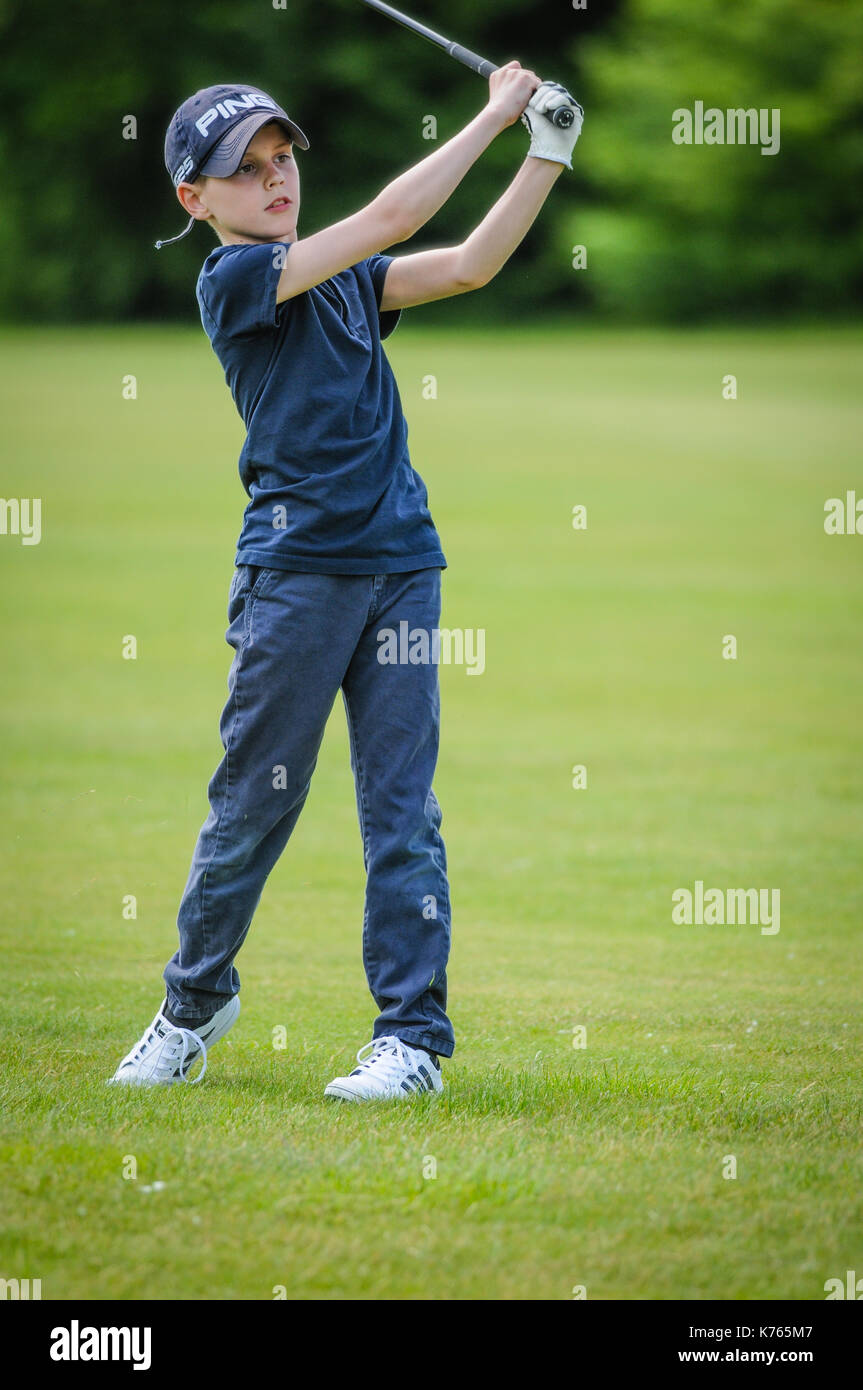 Junior child teenager playing golf in England UK Stock Photo - Alamy