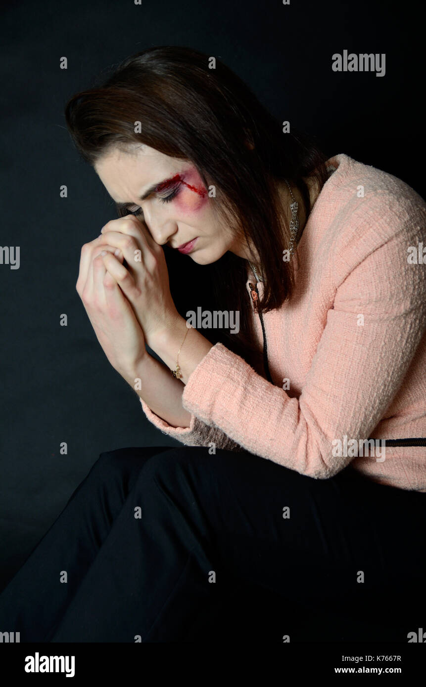 Home violence. Beaten woman with injuries on face, bleeding, black eye ...