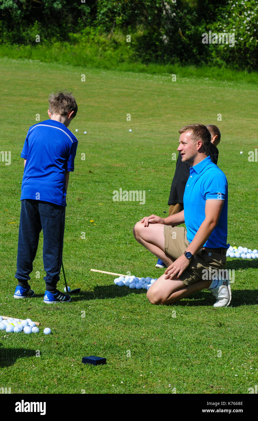 Junior child teenager playing golf in England UK Stock Photo - Alamy
