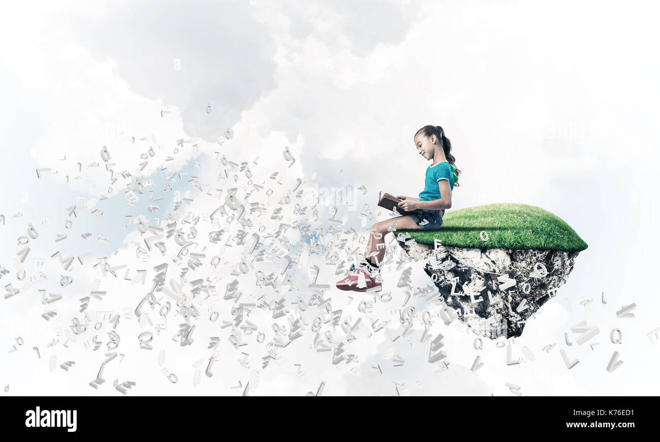 Girl of school age reading book as concept for education Stock Photo ...