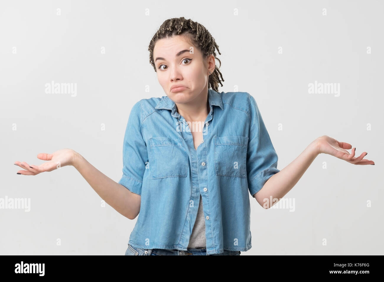 Portrait of caucasian girl with braids having doubtful and indecisive ...