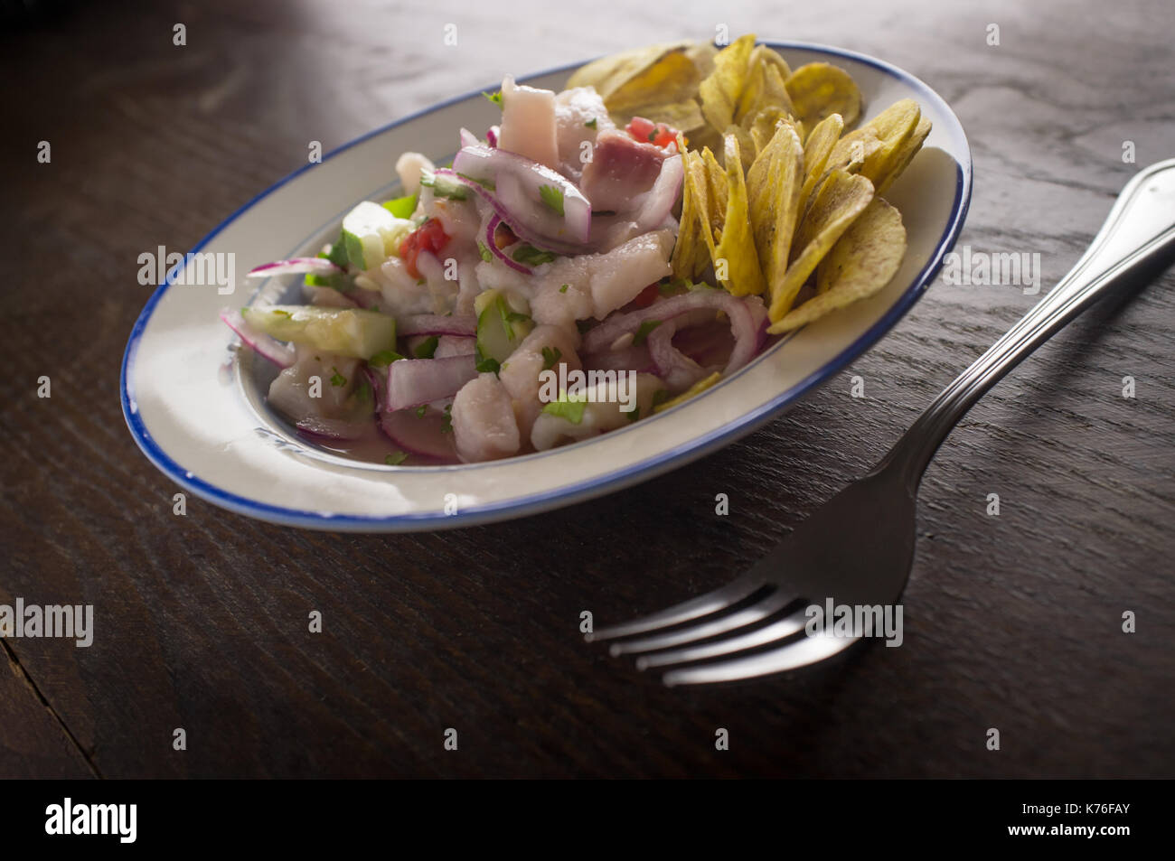 Chilled spicy ceviche with crispy fried plantain chips Stock Photo - Alamy