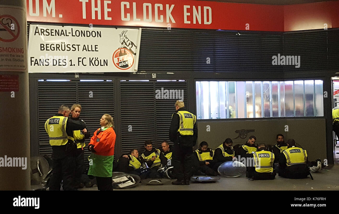 Police officers take a break outside the Emirates Stadium, north London ...