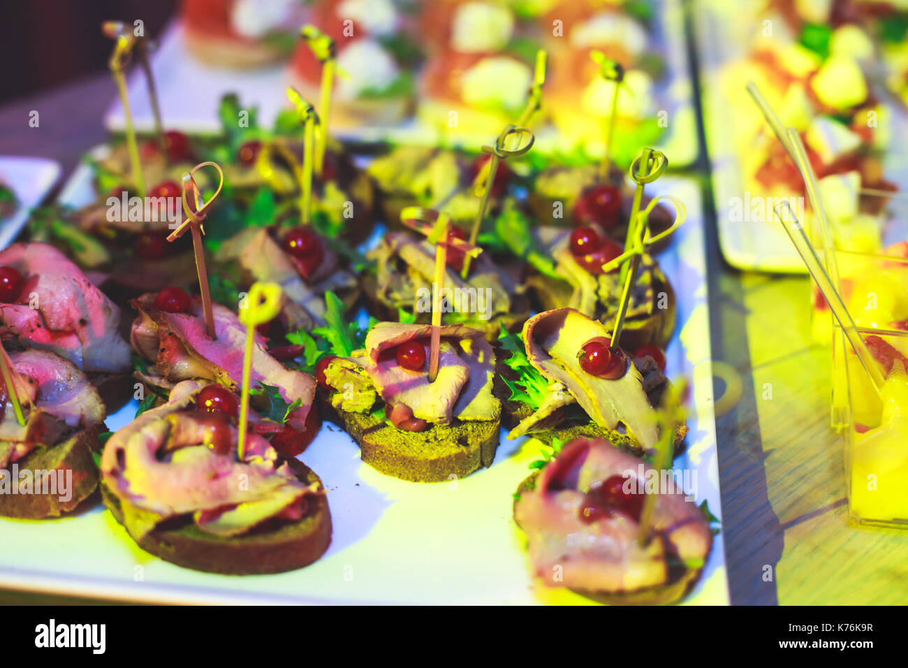 Beautifully decorated catering banquet table with different food snacks ...