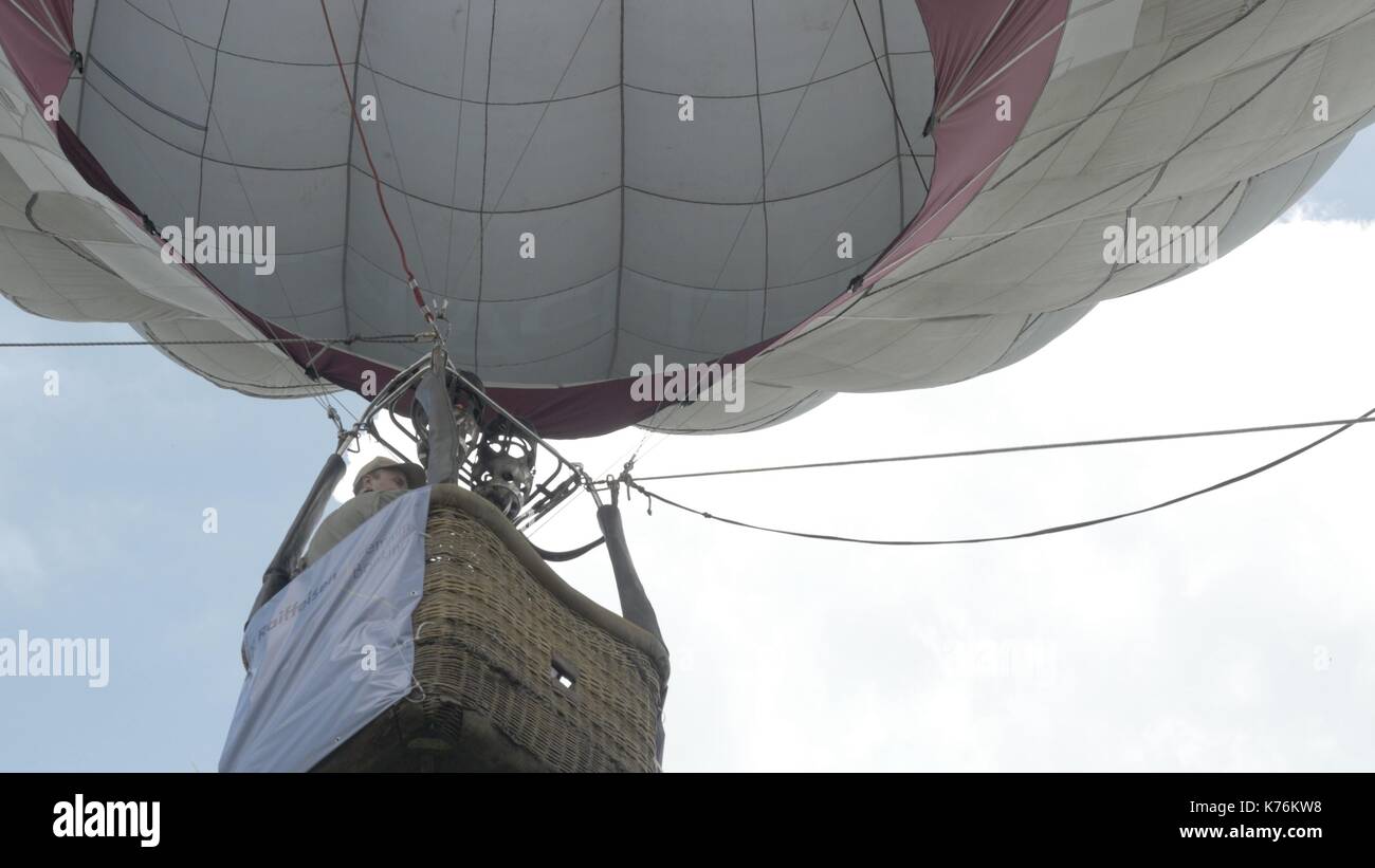 Close up of a hot air balloon flying in the sky. Flying-up balloon with ...