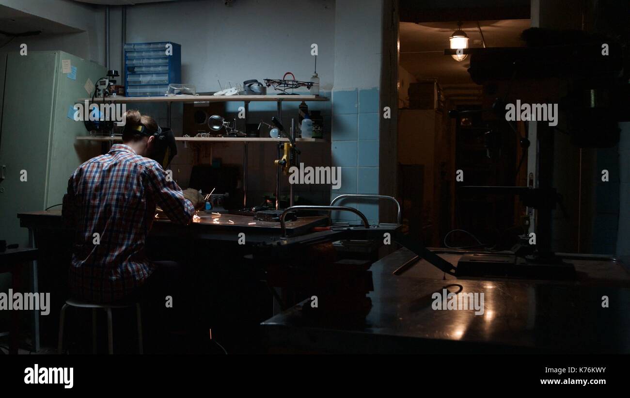 Back view of professional welder man with torch and protective mask ...