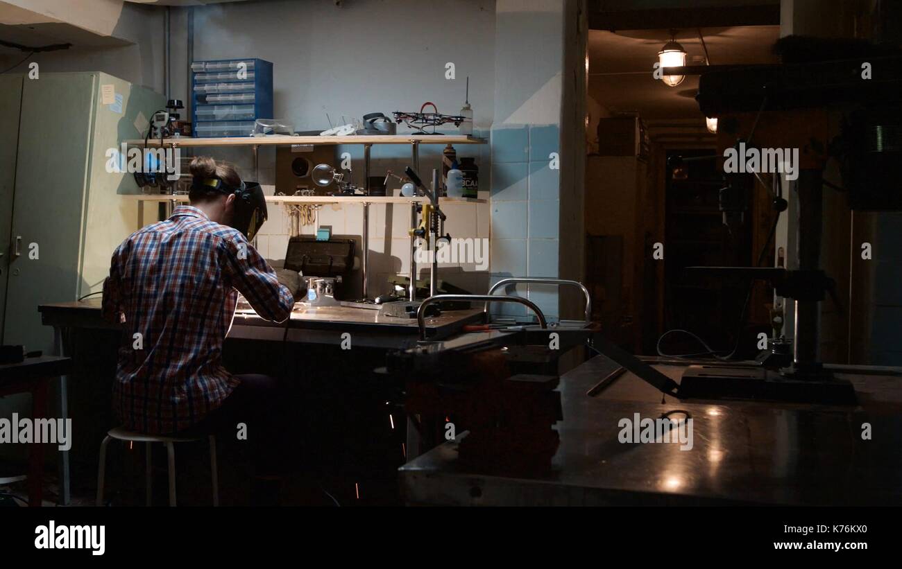Back view of professional welder man with torch and protective mask ...