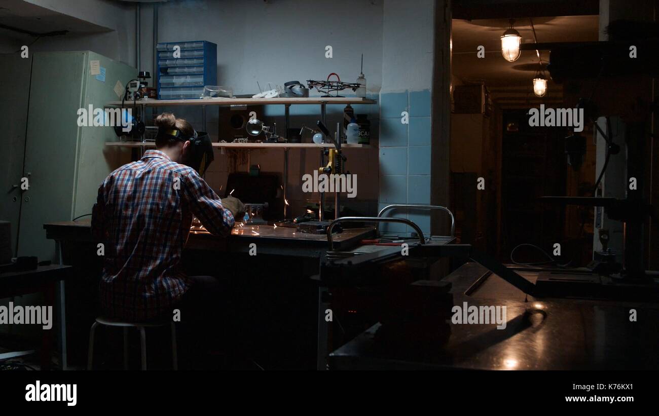 Back view of professional welder man with torch and protective mask ...