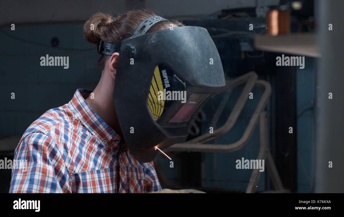 Close-up of welder working in workshop. A close-up of a strong male ...