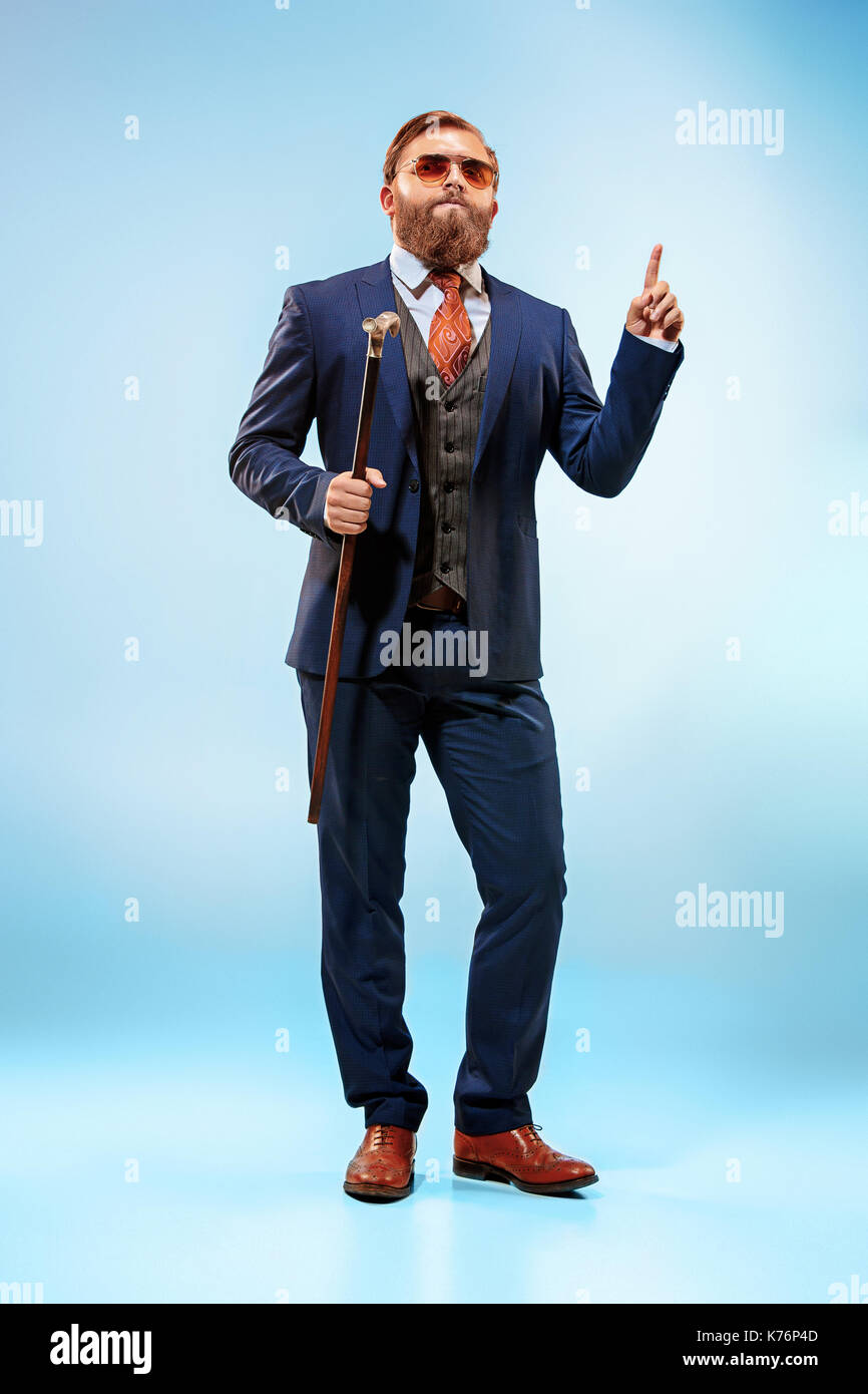 The barded man in a suit holding cane Stock Photo - Alamy