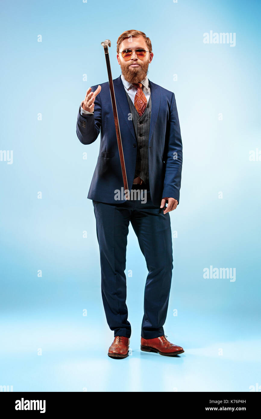 The barded man in a suit holding cane Stock Photo - Alamy