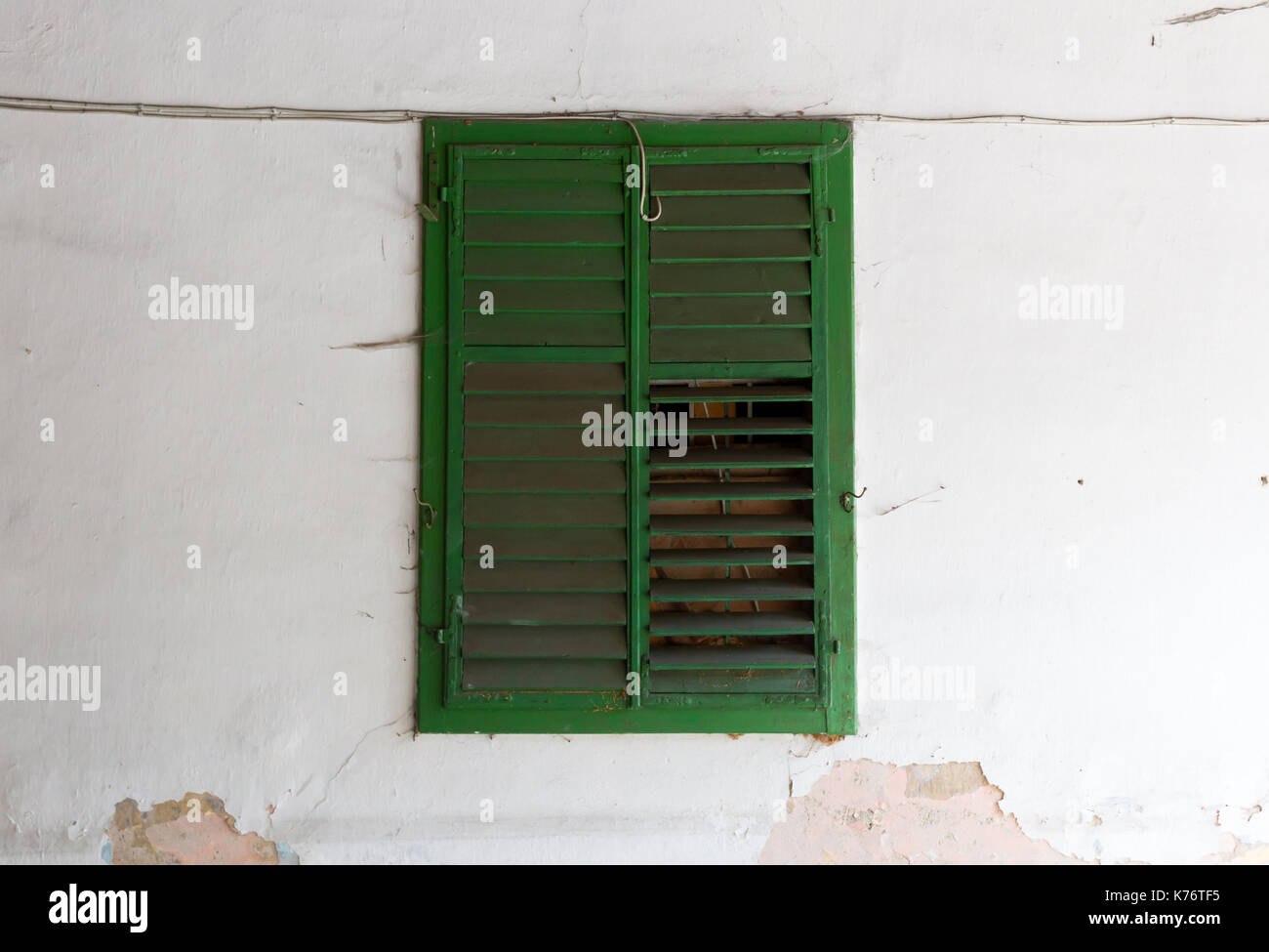 Green shutter on an old wall Stock Photo - Alamy