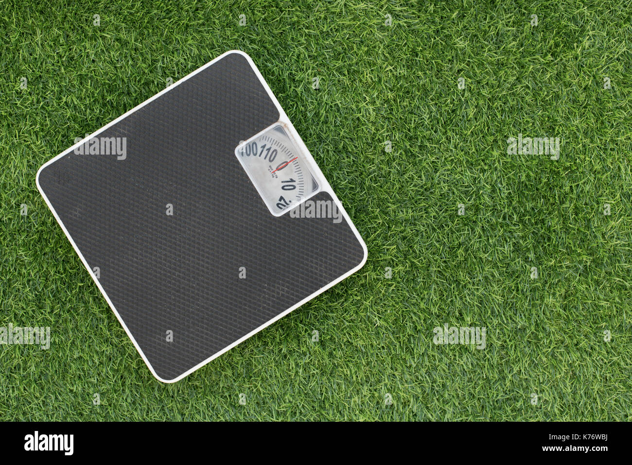 Weighing Scale on a green grass. fitness concept. Weight loss concept ...