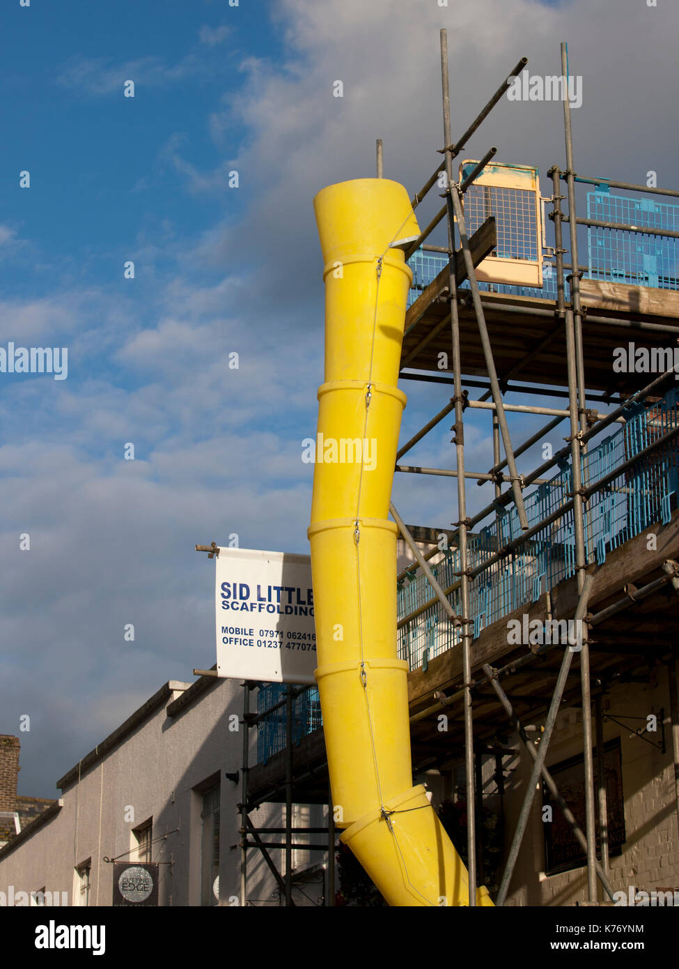 Scaffold with yellow rubbish chute in Barnstaple, Devon, UK Stock Photo ...