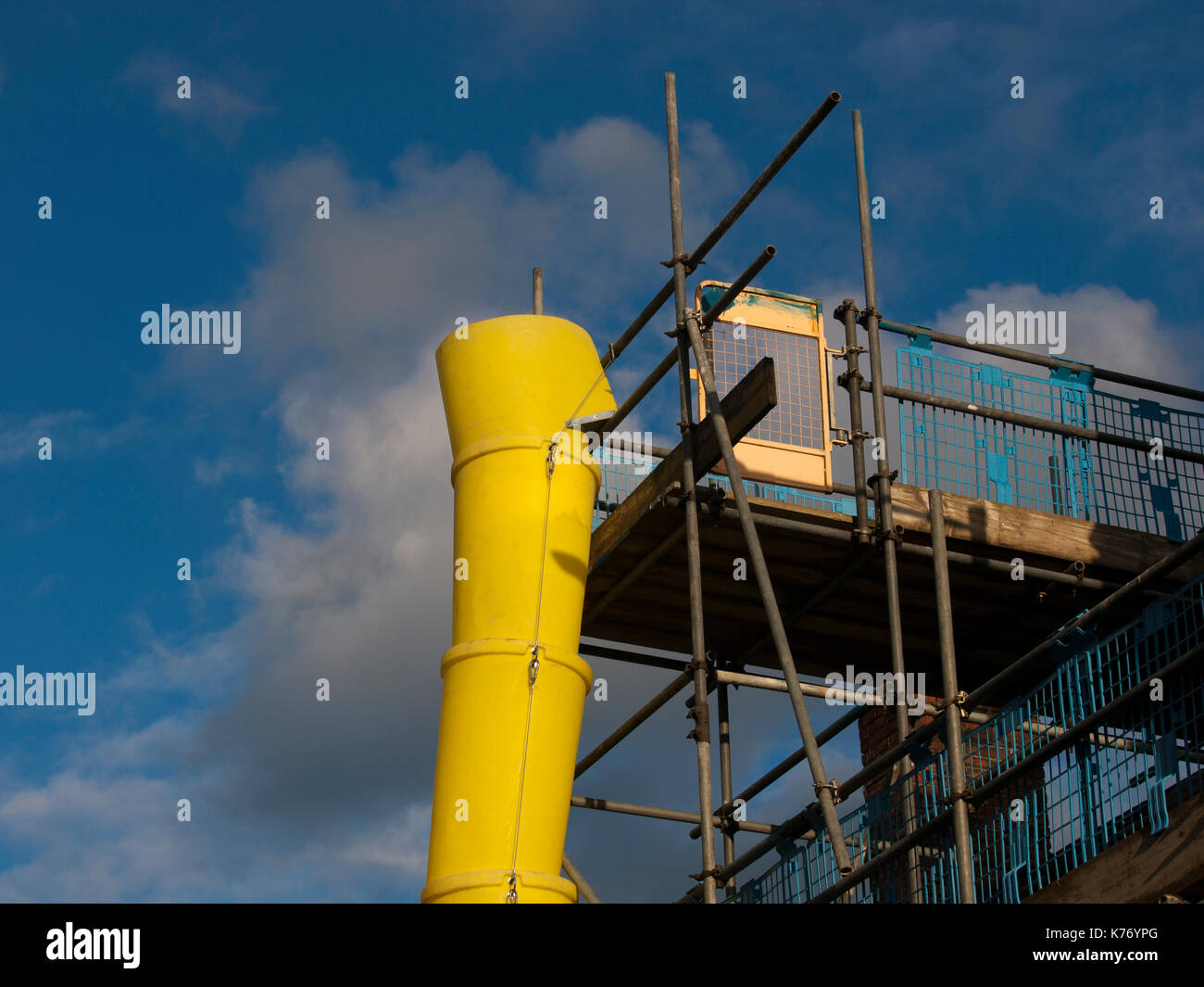Scaffold with yellow rubbish chute in Barnstaple, Devon, UK Stock Photo ...