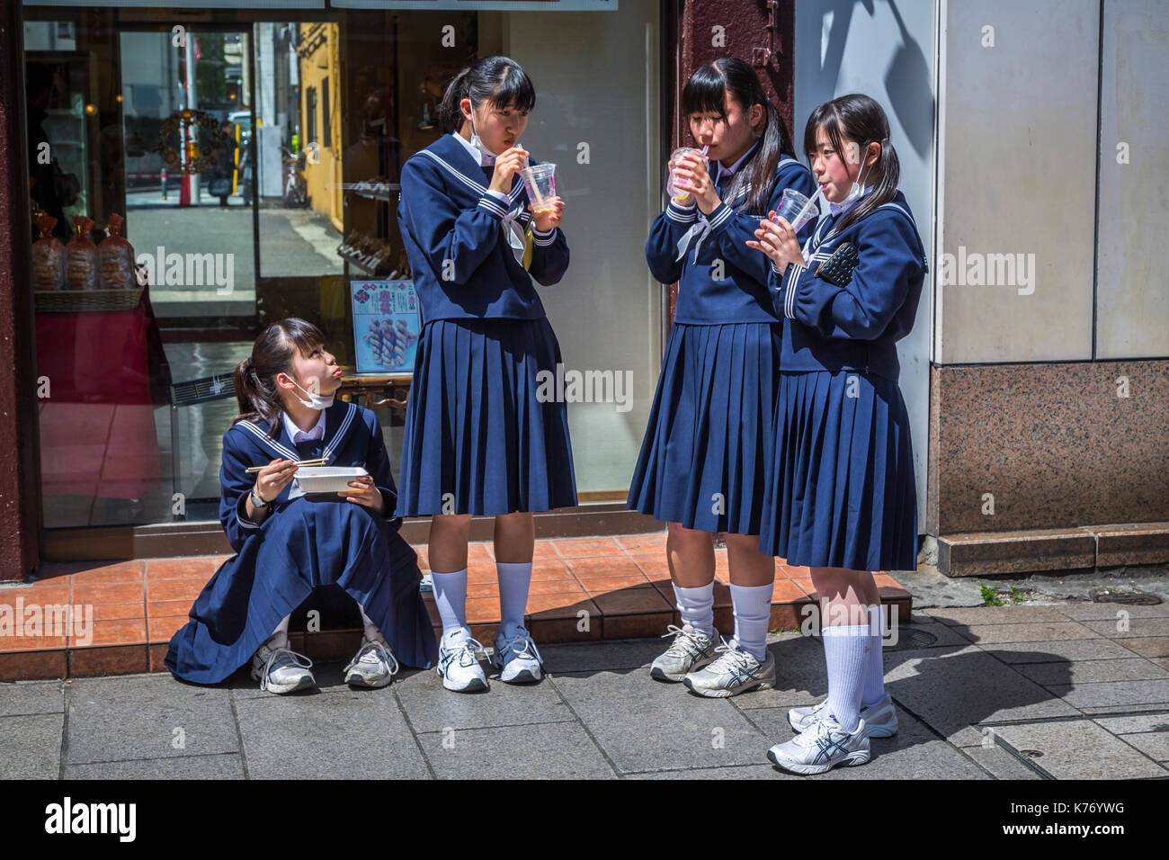 Japanese school girls sampling street food in Chinatown, Yokohama ...