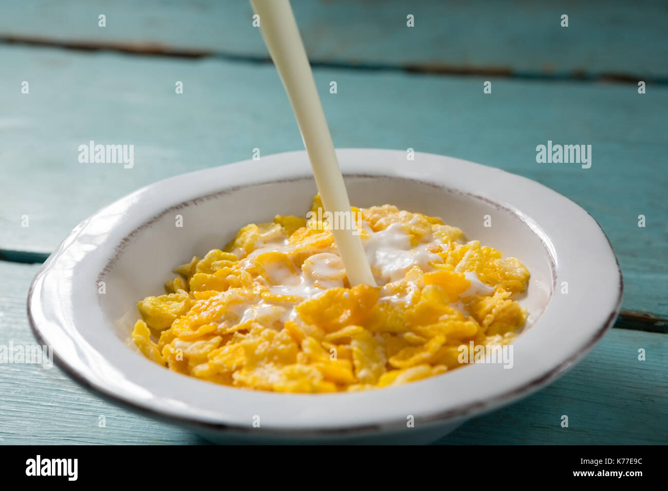 Close-up of pouring milk into bowl of wheaties cereal Stock Photo - Alamy