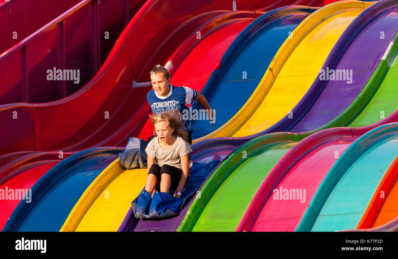 Landscape and portrait images of the midway, rides and games at an ...