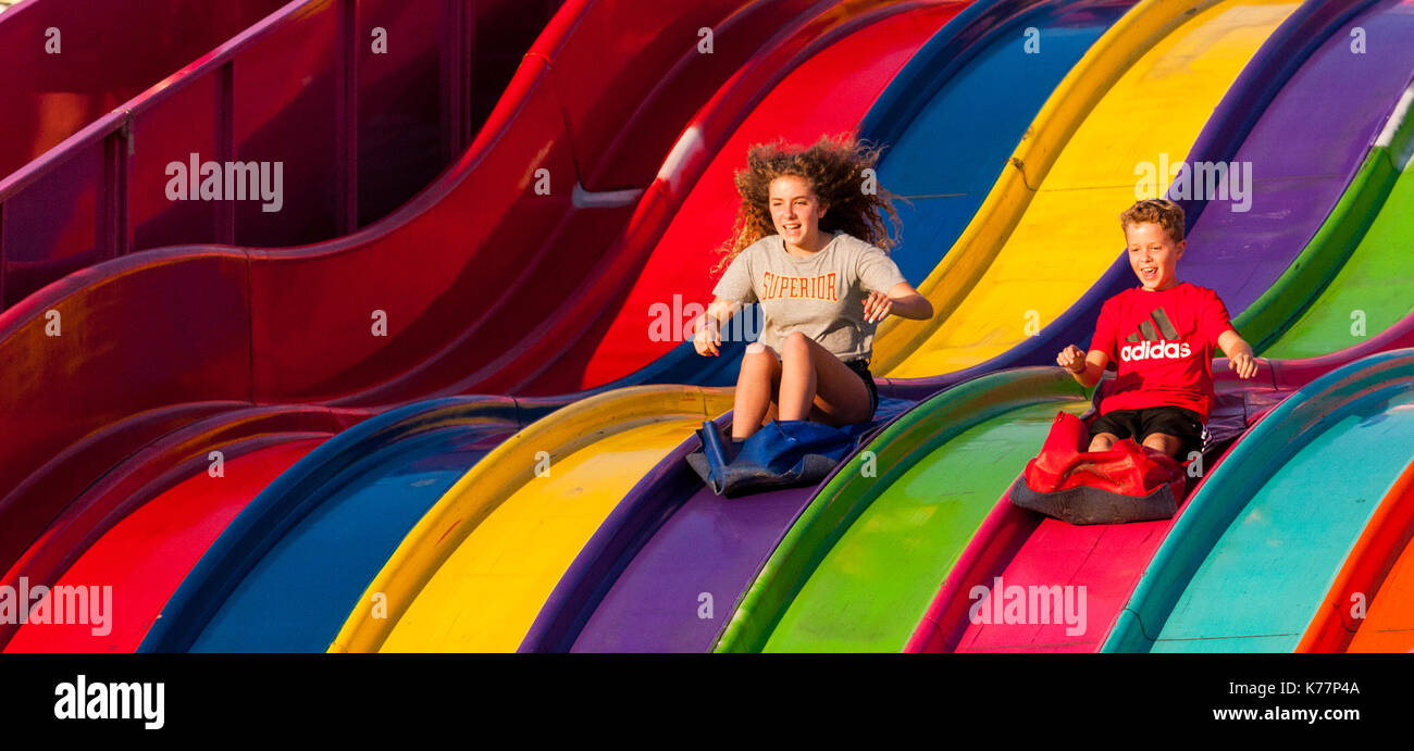 Landscape and portrait images of the midway, rides and games at an ...