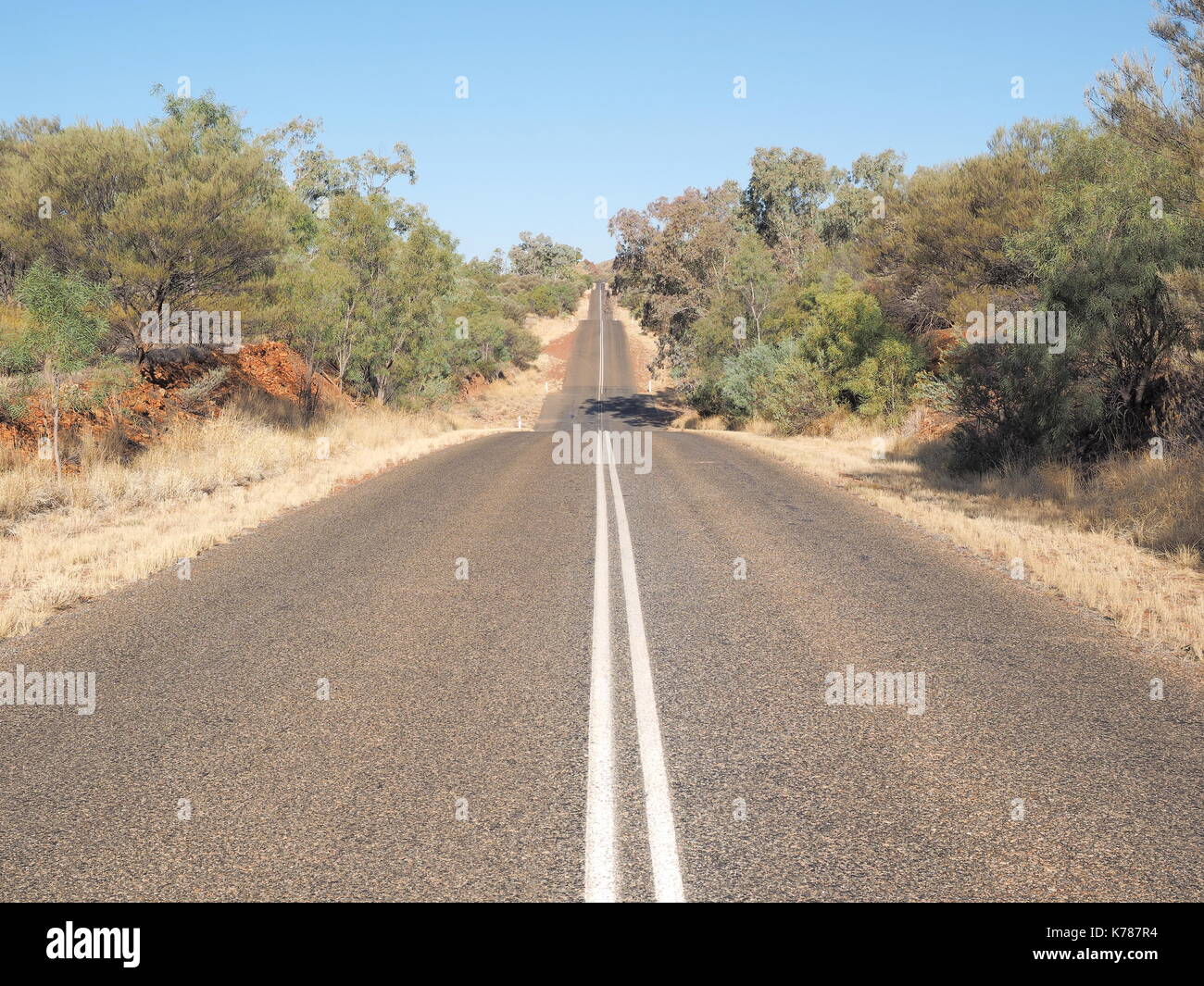 The hot bitumen road to the horizon at Larapinta Drive, west MacDonnell ...