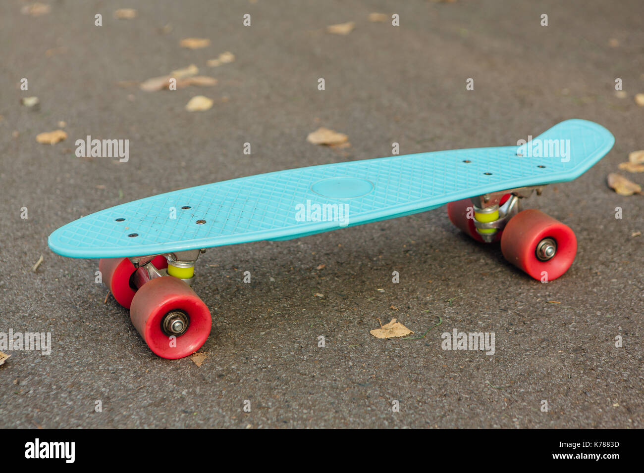 Blue penny board with pink wheels stands on the track Stock Photo - Alamy