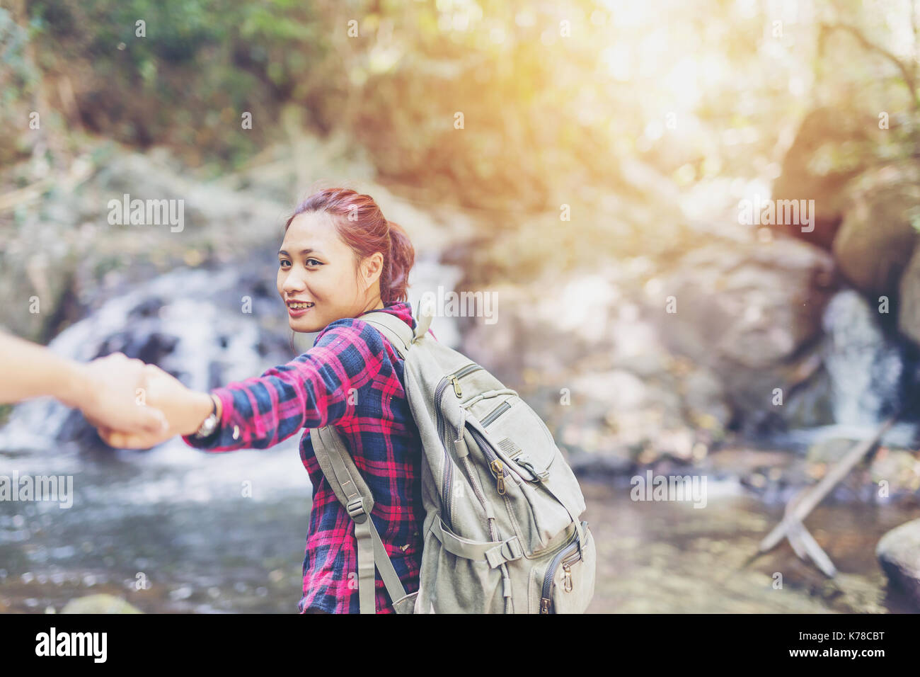 Hiking young woman with backpack watching trekking map, Hiking concept ...