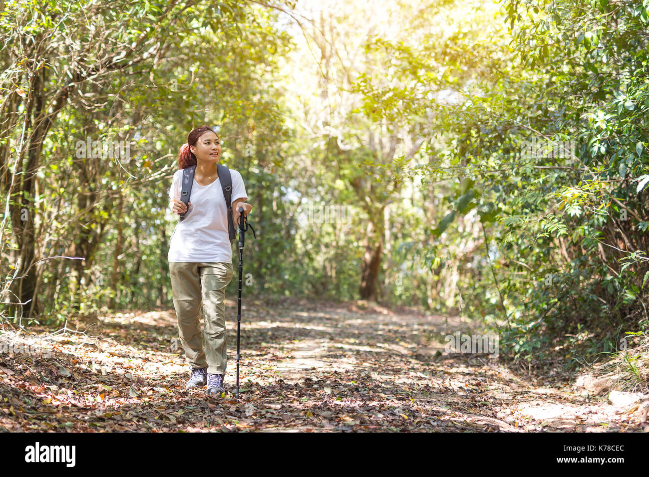 Hiking young woman with backpack watching trekking map, Hiking concept ...