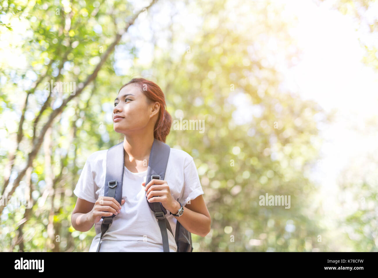 Hiking young woman with backpack watching trekking map, Hiking concept ...