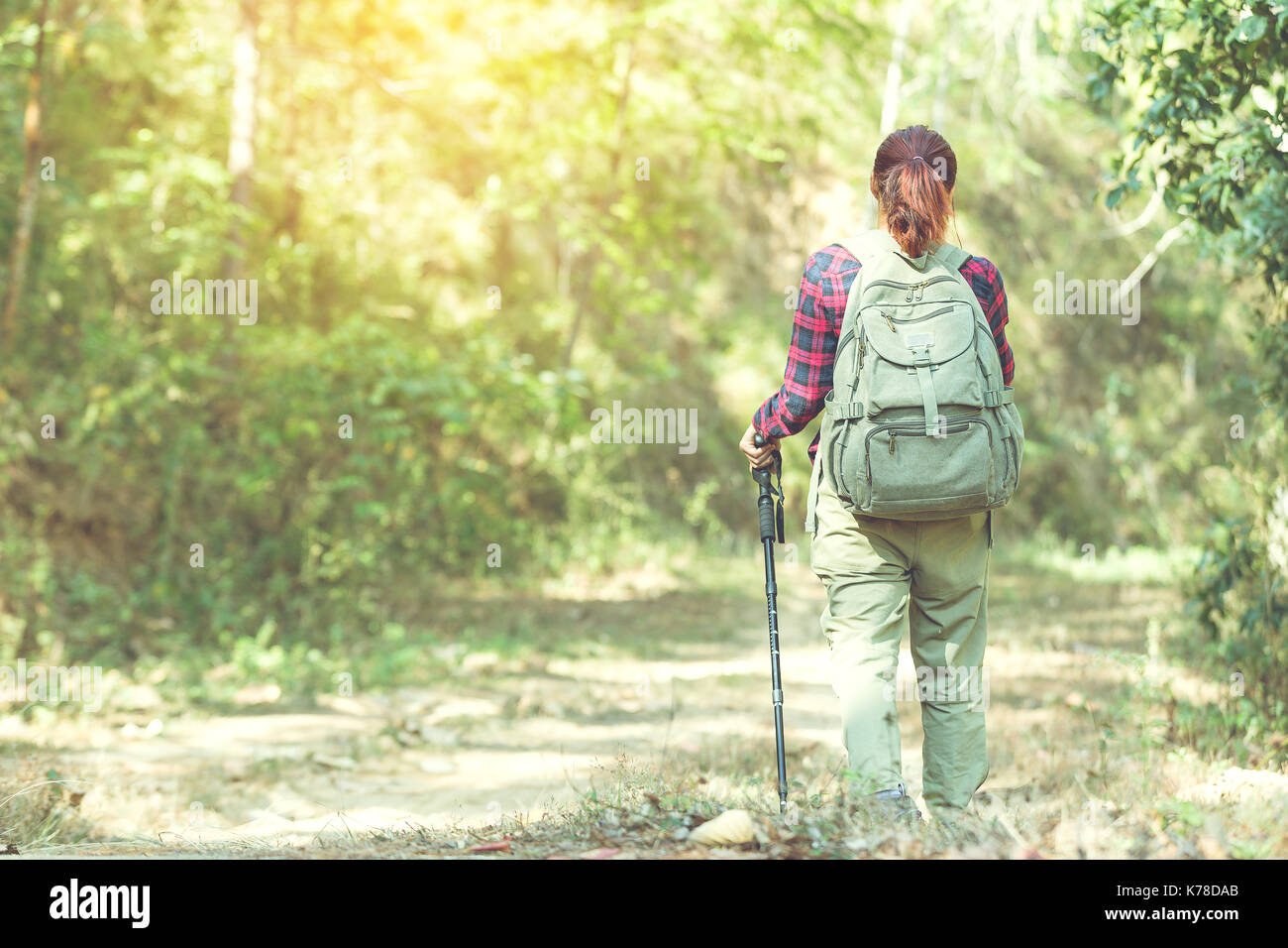 Hiking young woman with backpack watching trekking map, Hiking concept ...
