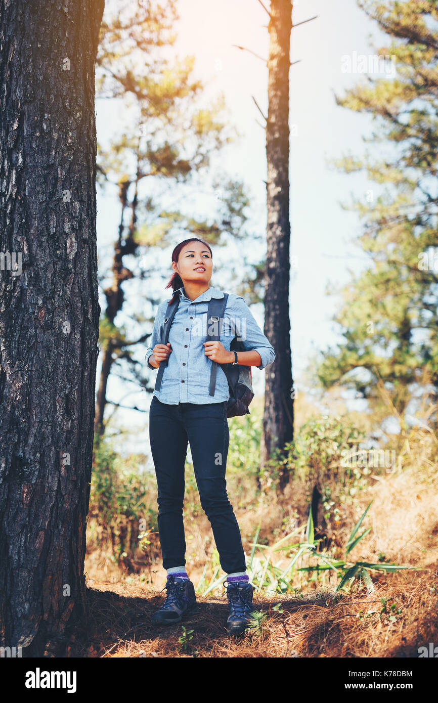 Hiking young woman with backpack watching trekking map, Hiking concept ...