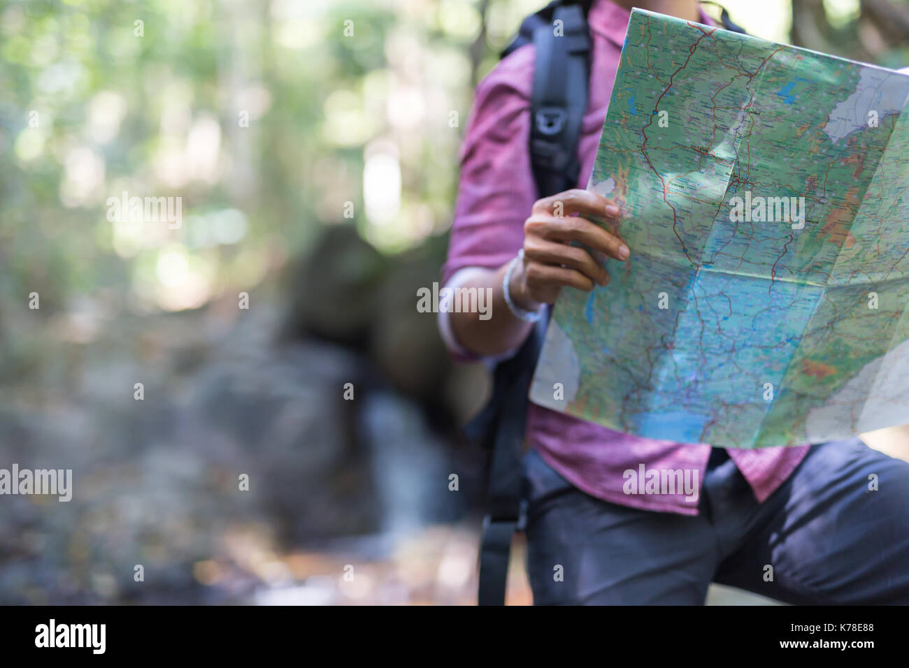 Young man reading map in forest Vintage style Stock Photo - Alamy