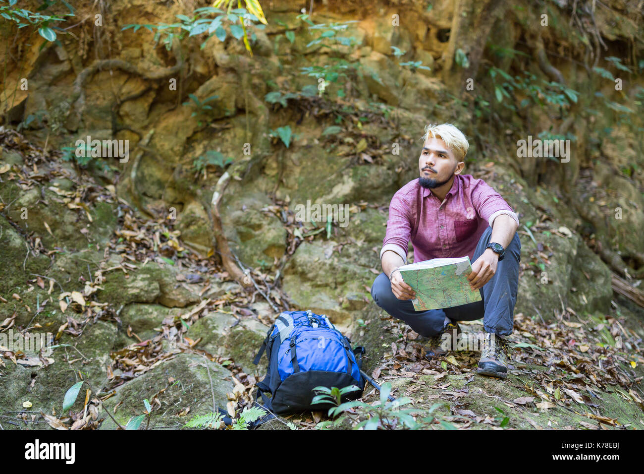 Young man reading map in forest Vintage style Stock Photo - Alamy