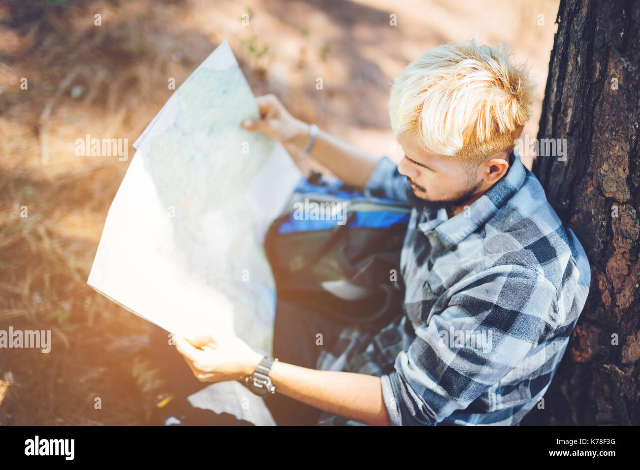 Young man reading map in forest Vintage style Stock Photo - Alamy