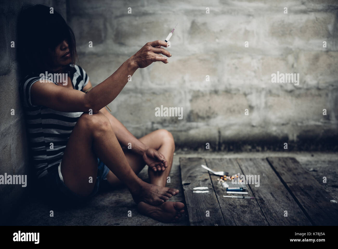 Drug addict young woman with syringe in action, Drug abuse concept ...