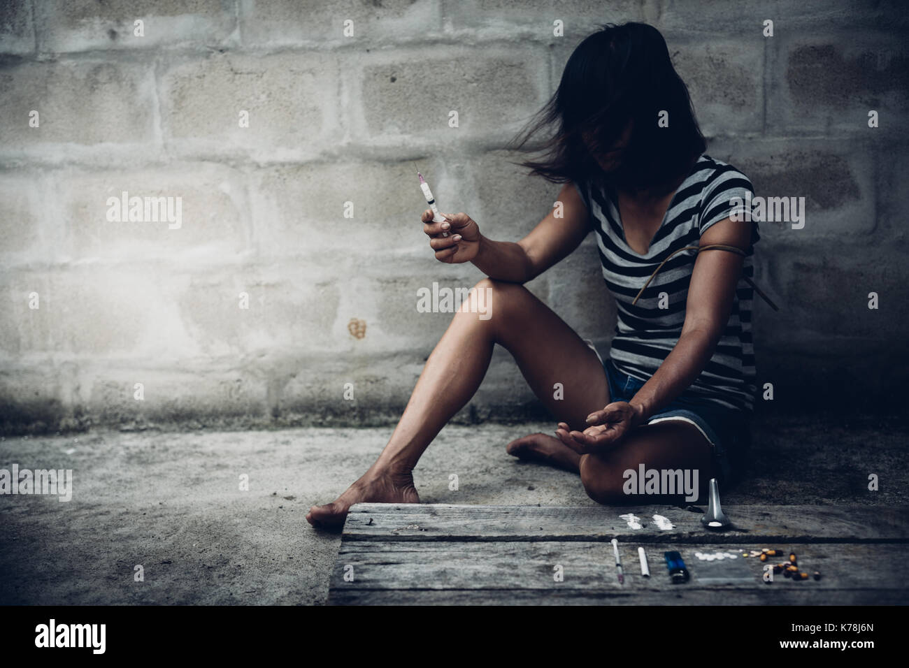 Drug addict young woman with syringe in action, Drug abuse concept ...