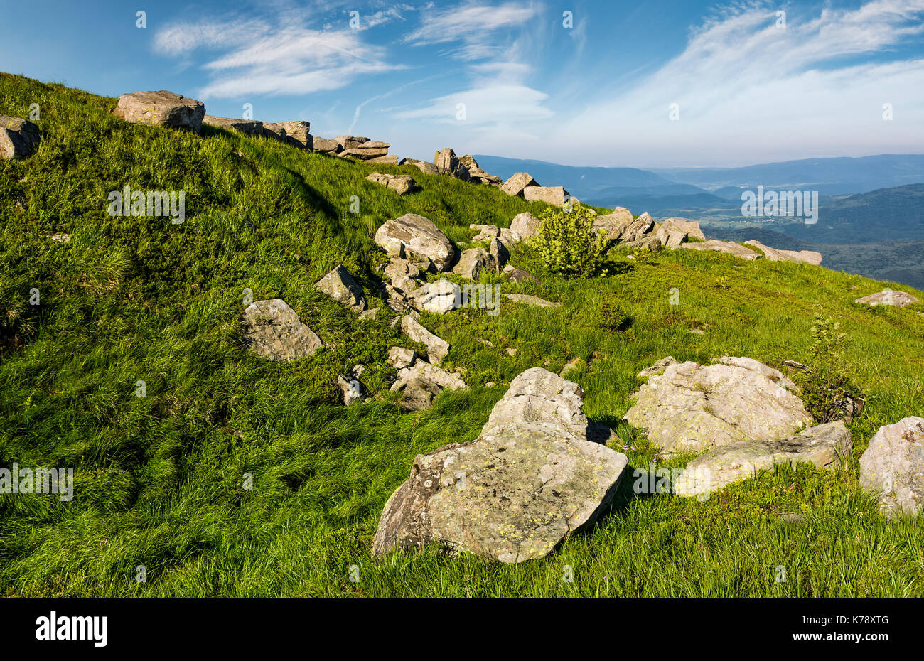 huge boulders on a grassy slope in mountains. lovely mountain landscape ...