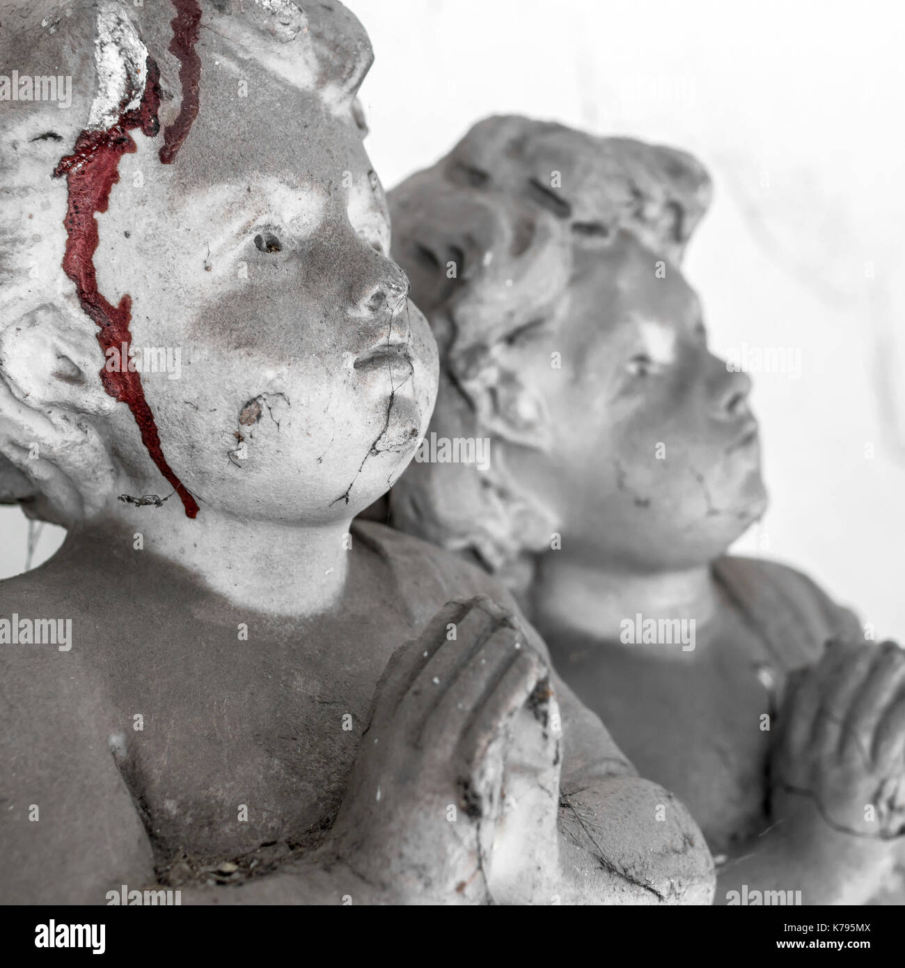 Statue of children, covered with cobwebs and dried blood. Concept of ...
