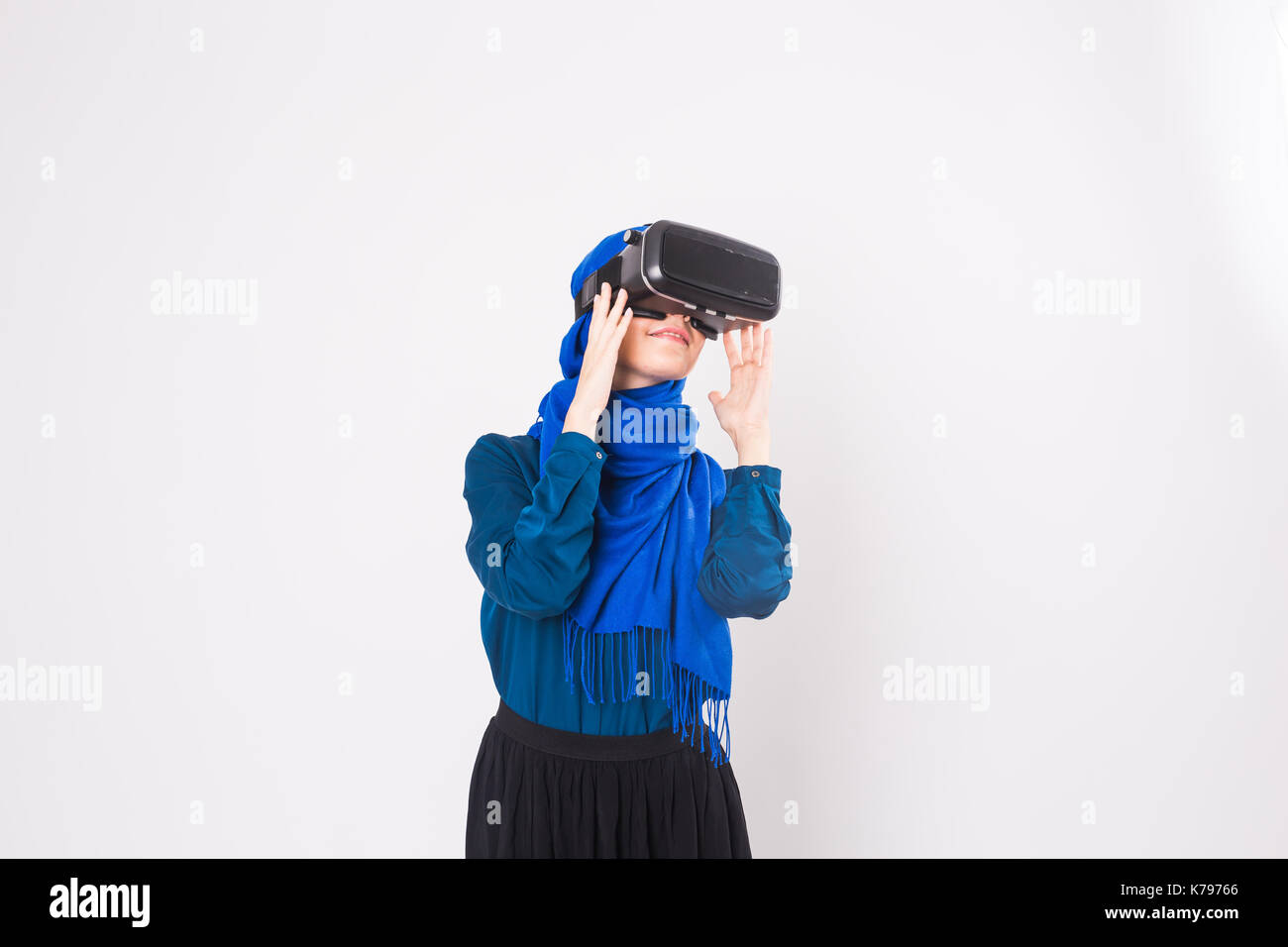 Muslim woman using VR headset. technology, vr, people and game concept ...