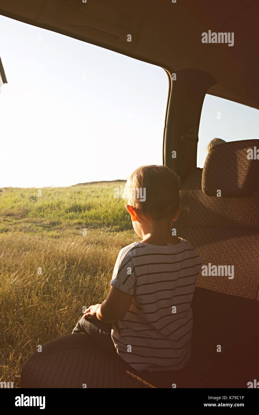 Child in the car and looks into the distance Stock Photo - Alamy