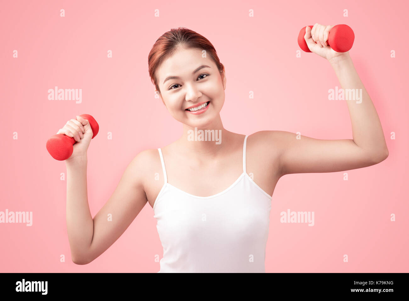 Woman Lifting Weights. Fitness woman lifting weights smiling happy on ...