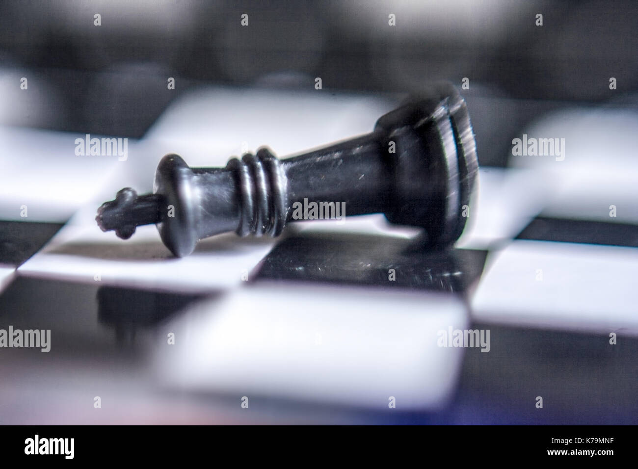 Black queen down on the chess board Stock Photo - Alamy