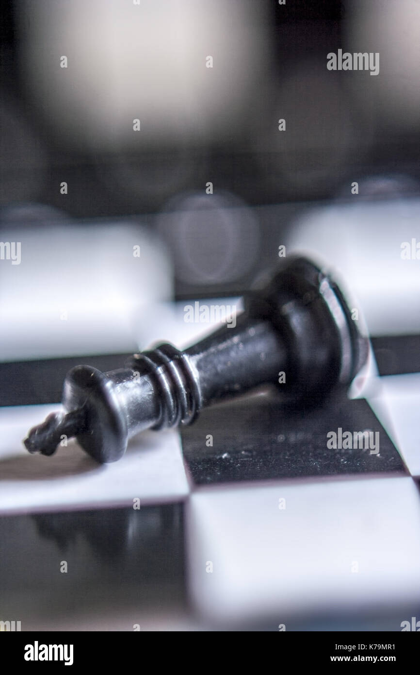 Black queen down on the chess board Stock Photo - Alamy